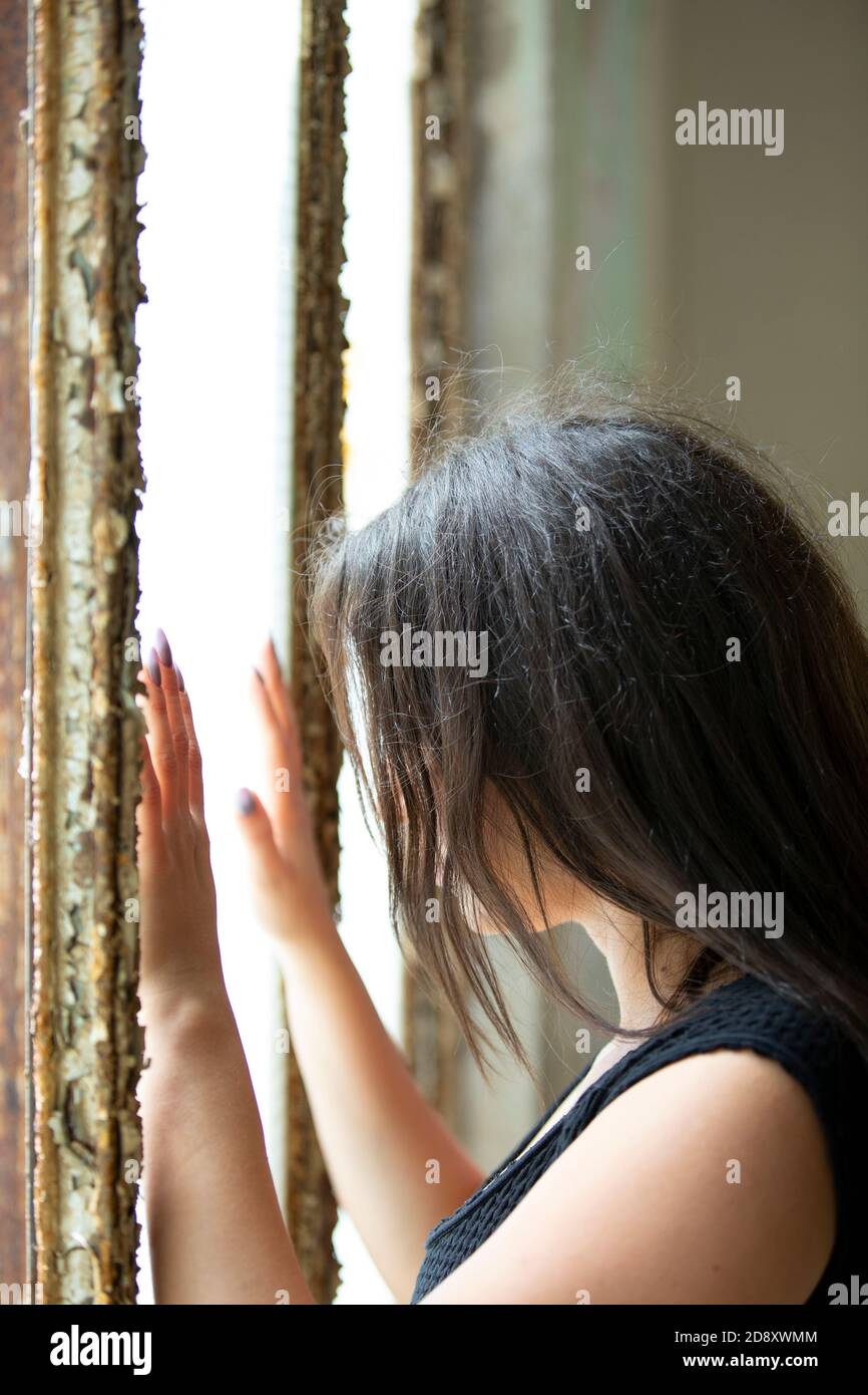 Side view of woman by the window Stock Photo - Alamy