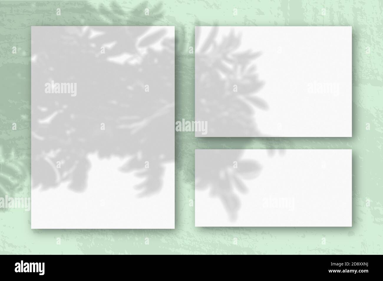 Several horizontal and vertical sheets of white textured paper against ...