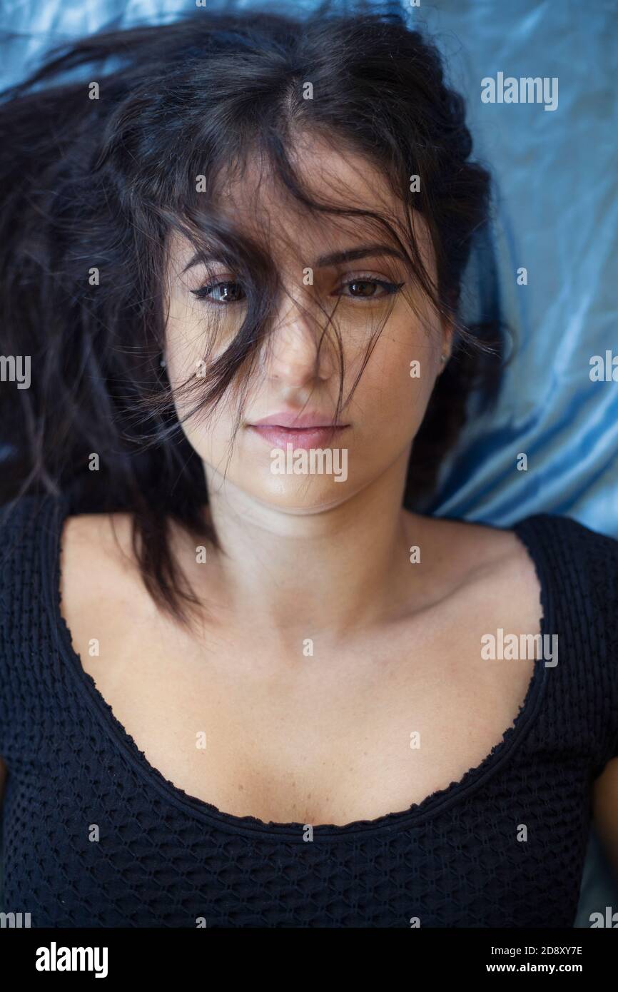 Beautiful woman hair covering face looking at camera Stock Photo - Alamy