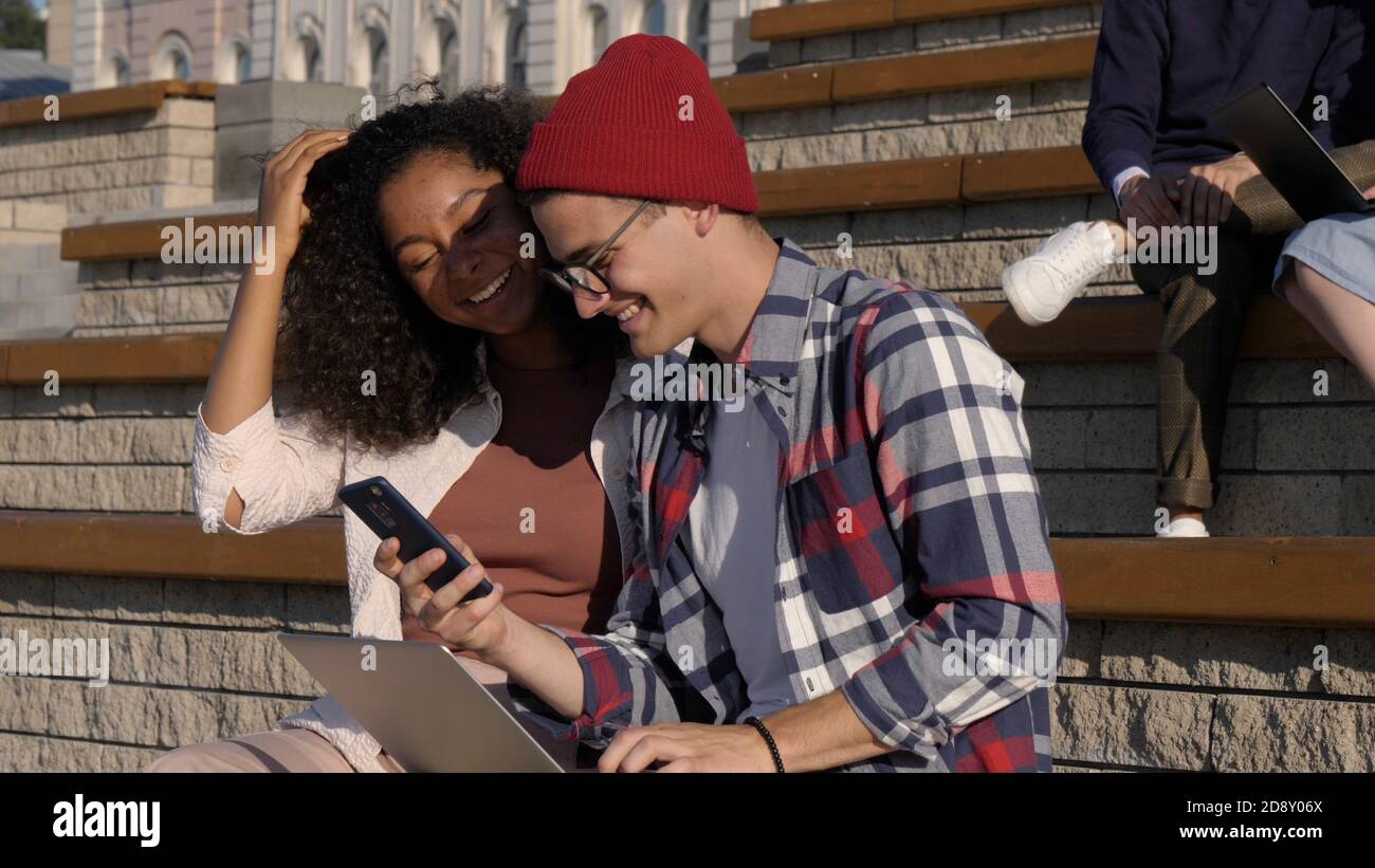 Millennial man and woman explore social media together using sma Stock ...