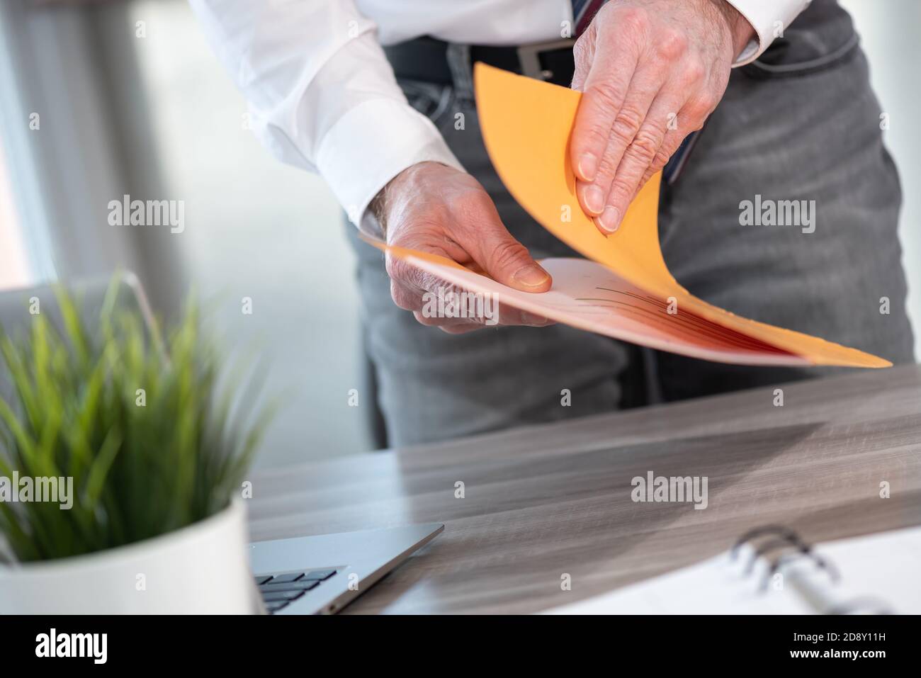 Businessman opening folder with paper documents Stock Photo - Alamy