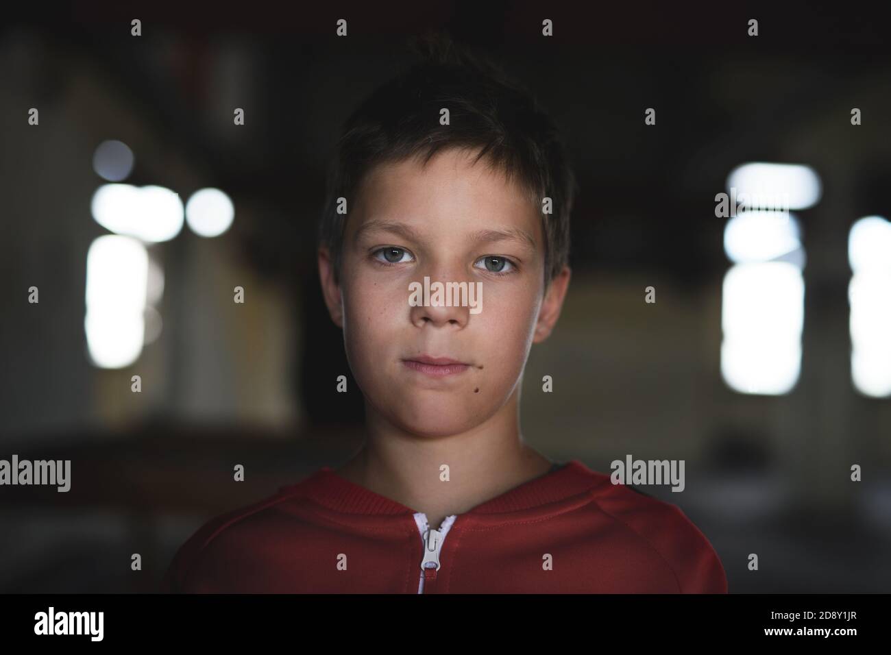 Sad and disappointed teenagers boy indoors in abandoned building ...