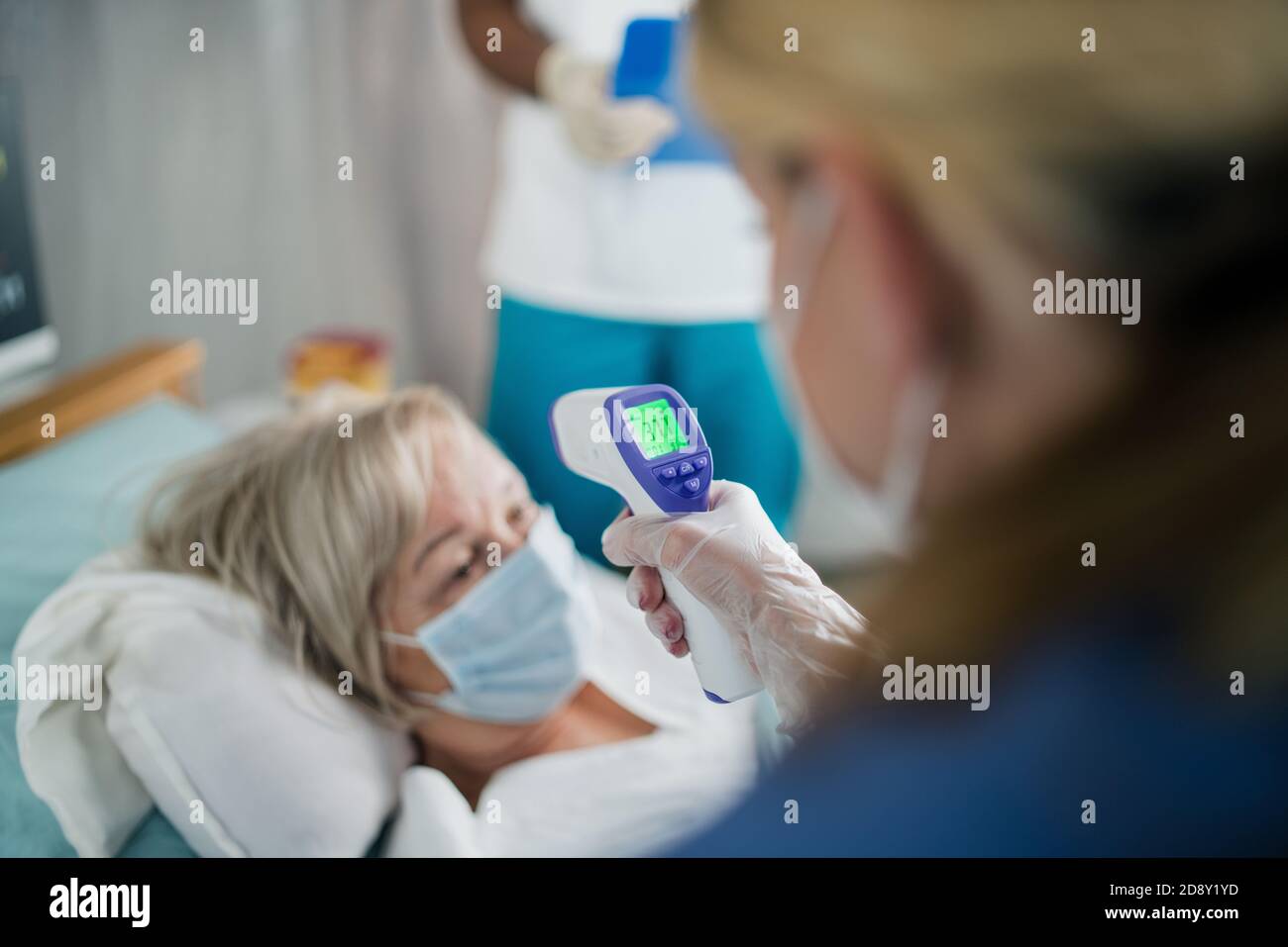 Doctor and covid-19 infected patient in bed in hospital, coronavirus ...