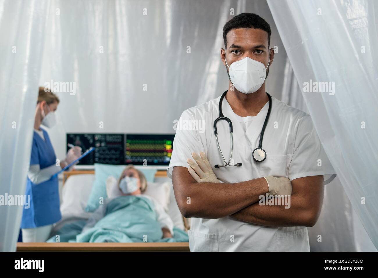 Doctor and covid-19 infected patient in bed in hospital, coronavirus ...