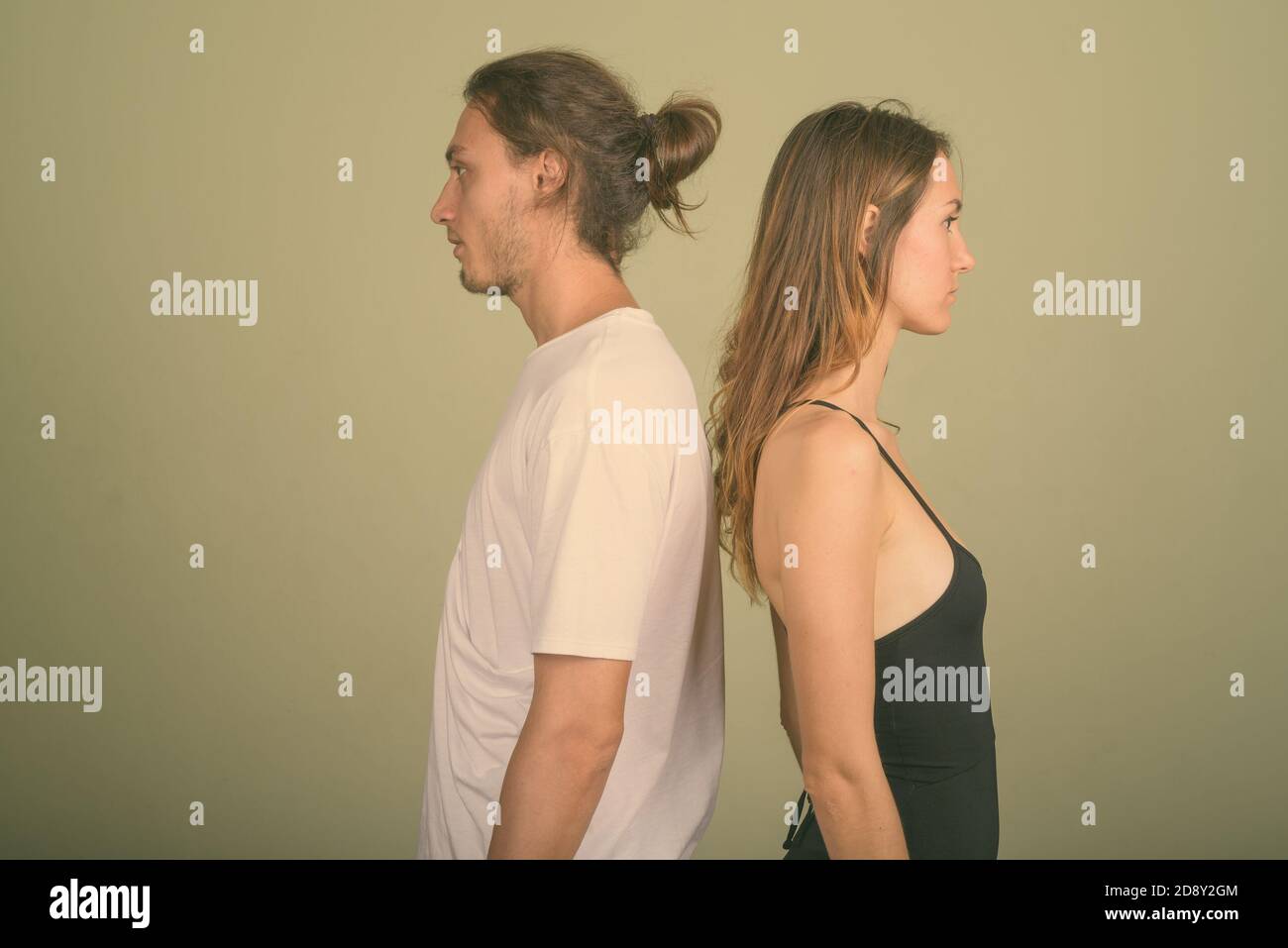 Young handsome man and young beautiful woman together against colored ...