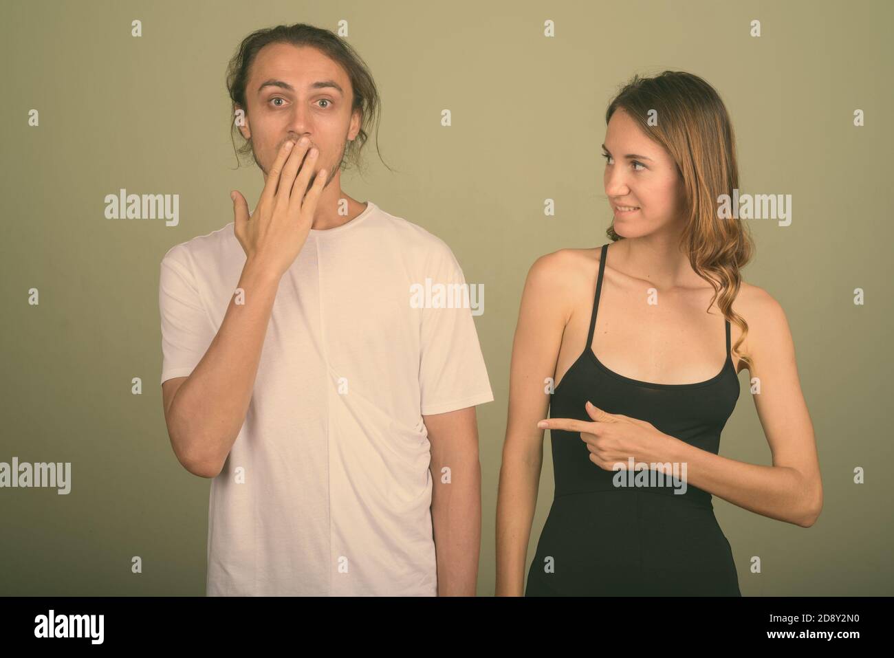 Young handsome man and young beautiful woman together against colored ...