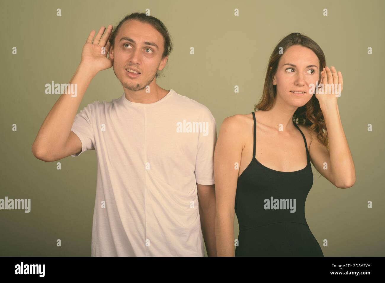 Young handsome man and young beautiful woman together against colored ...
