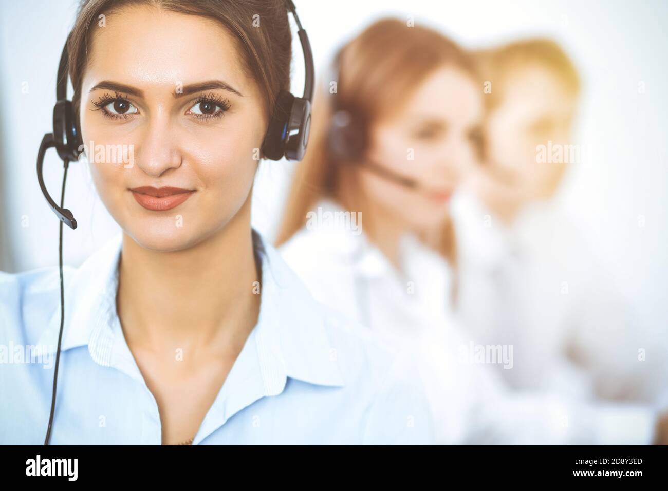 Call center. Focus on beautiful business woman in headset Stock Photo ...