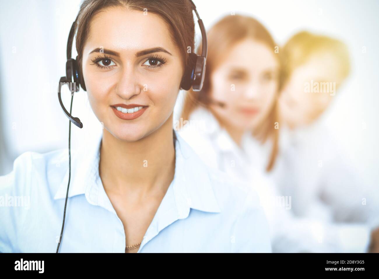 Call center. Focus on beautiful business woman in headset Stock Photo ...