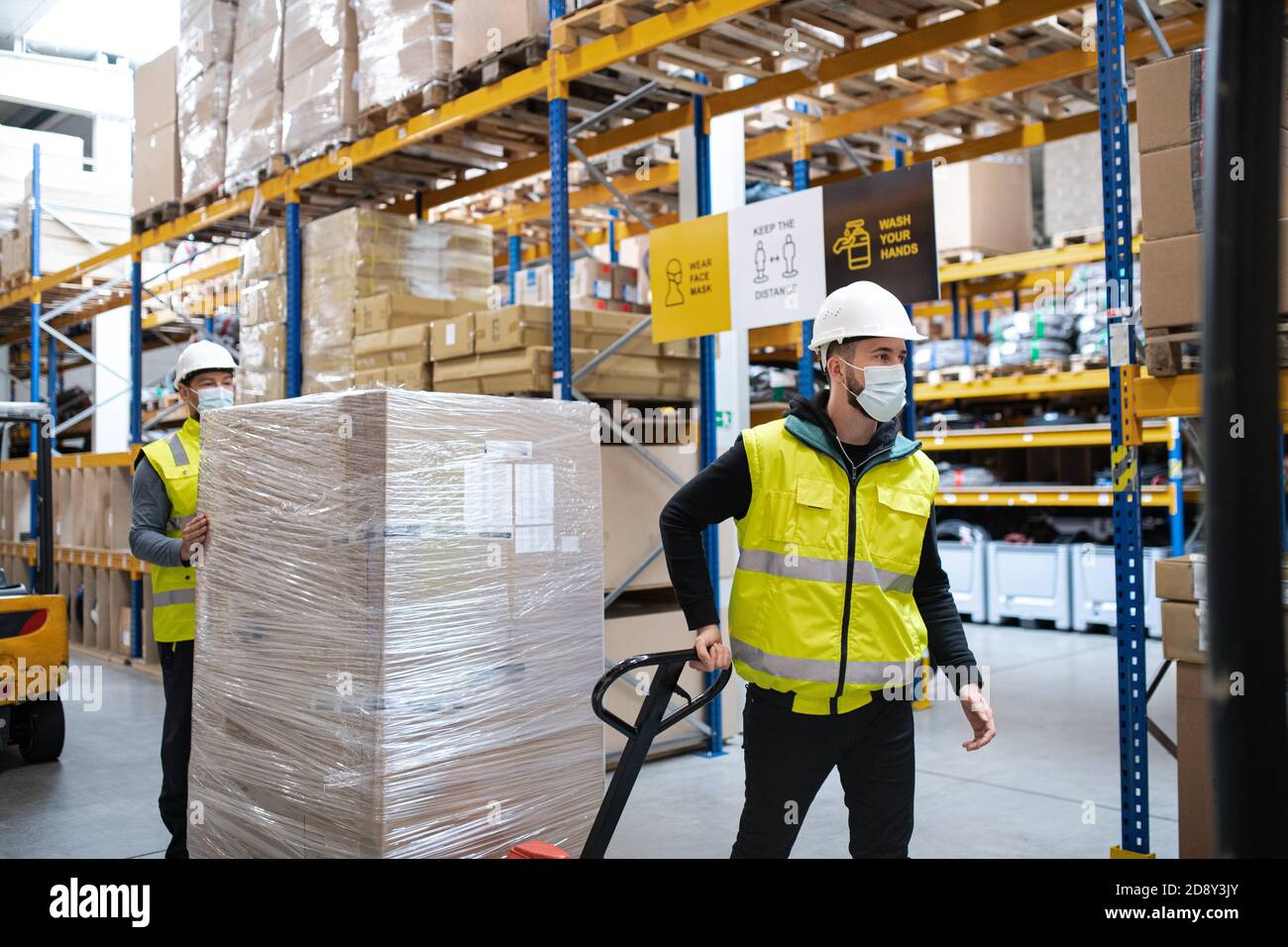 Group of workers with face mask working indoors in warehouse ...