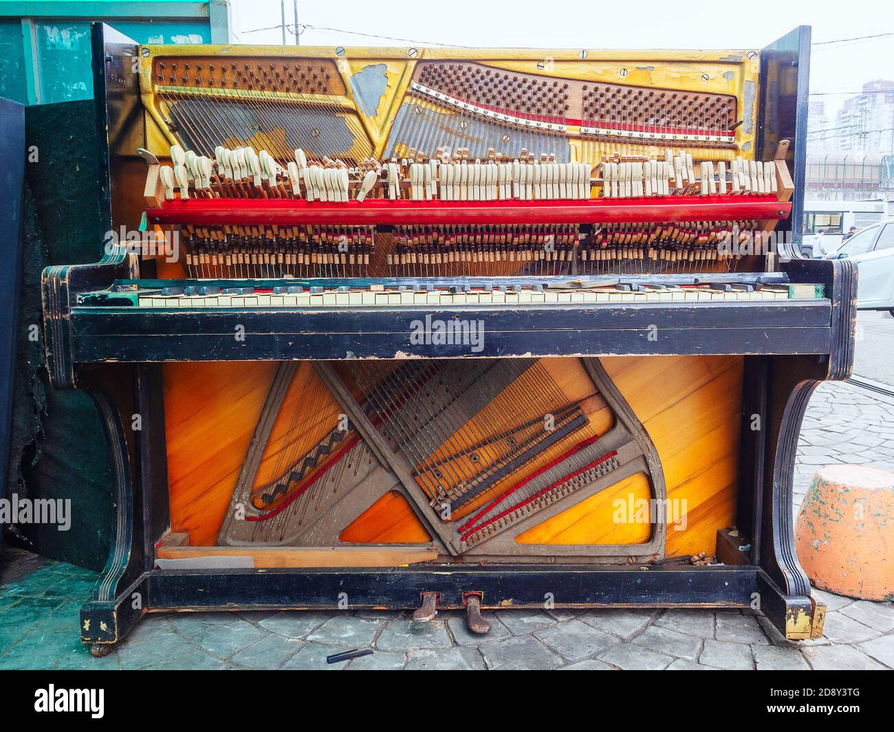 An old broken piano is on the street. Front view Stock Photo - Alamy