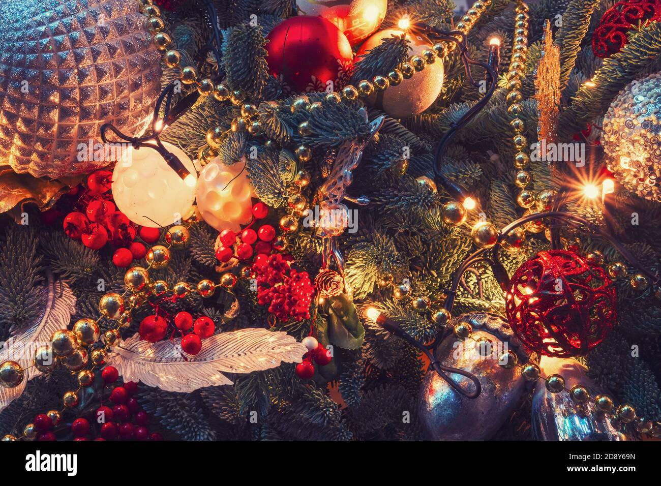 Christmas tree decorated with glass beads, mistletoe branch and baubles ...