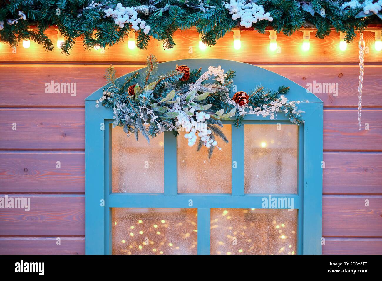 Roof and window of a wooden house decorated with Christmas tree ...