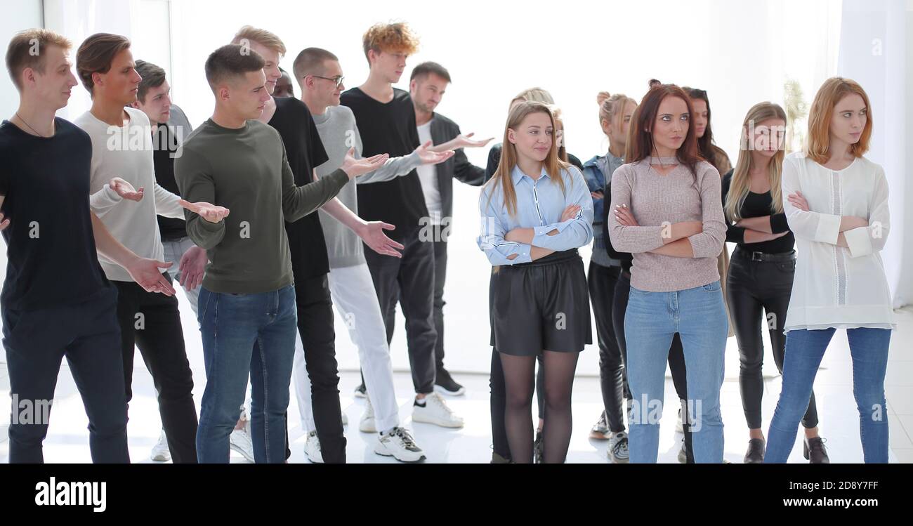 in full growth. young men ask questions to a group of women Stock Photo ...