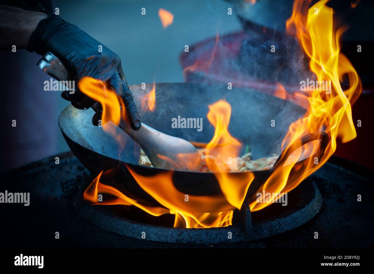 Cooking street food on a hot frying pan. Street food festival Stock ...