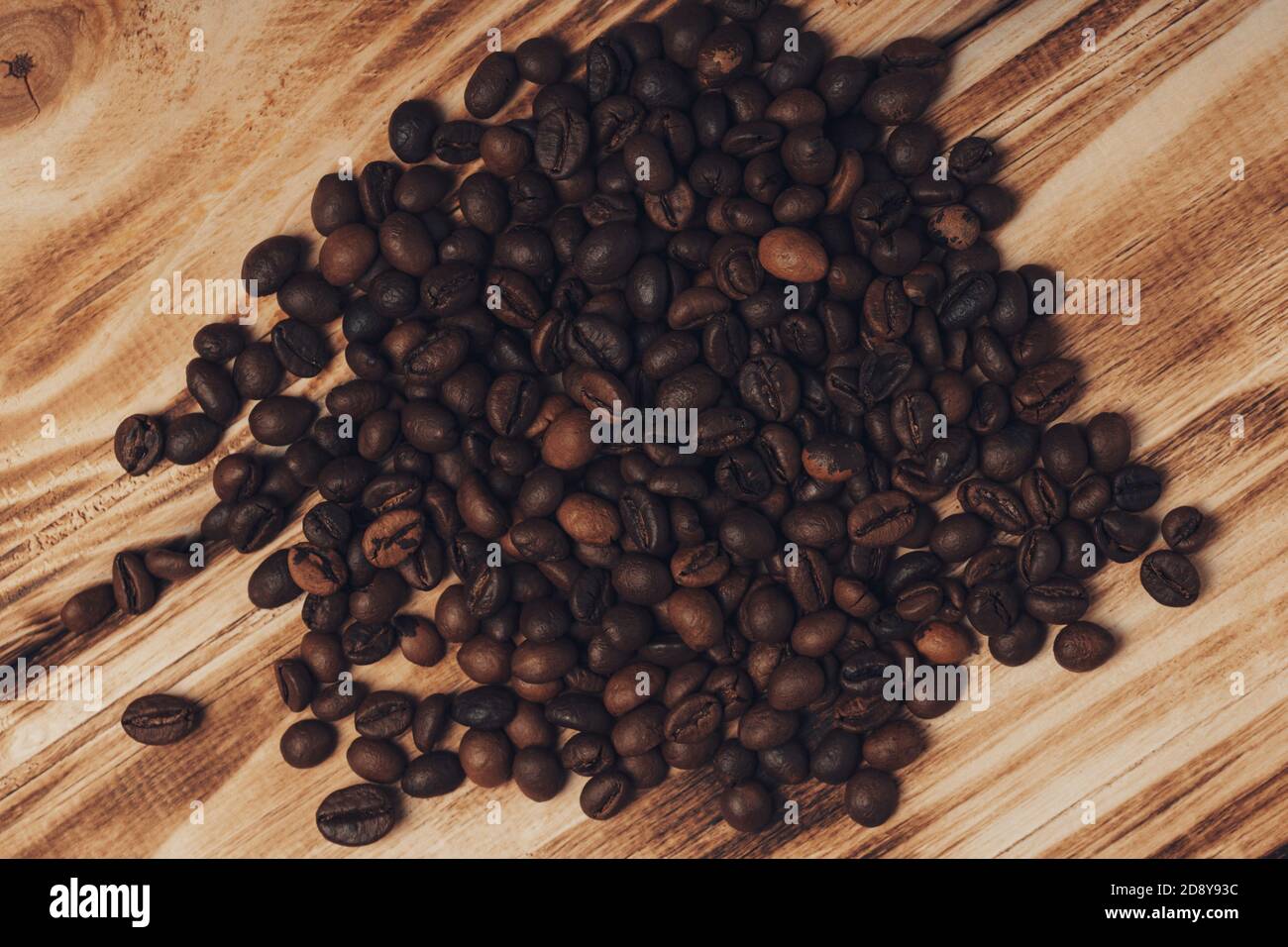Roasted coffee beans on rustic wood background Stock Photo - Alamy