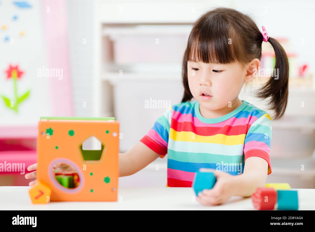 young girl playing number shape blocks for homeschooling Stock Photo ...