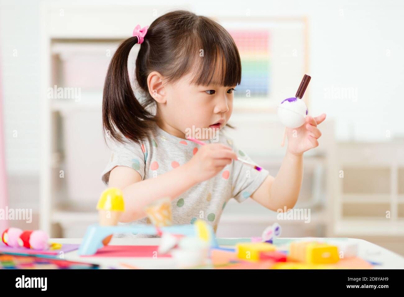 young girl decorating hand made craft for homeschooling Stock Photo - Alamy