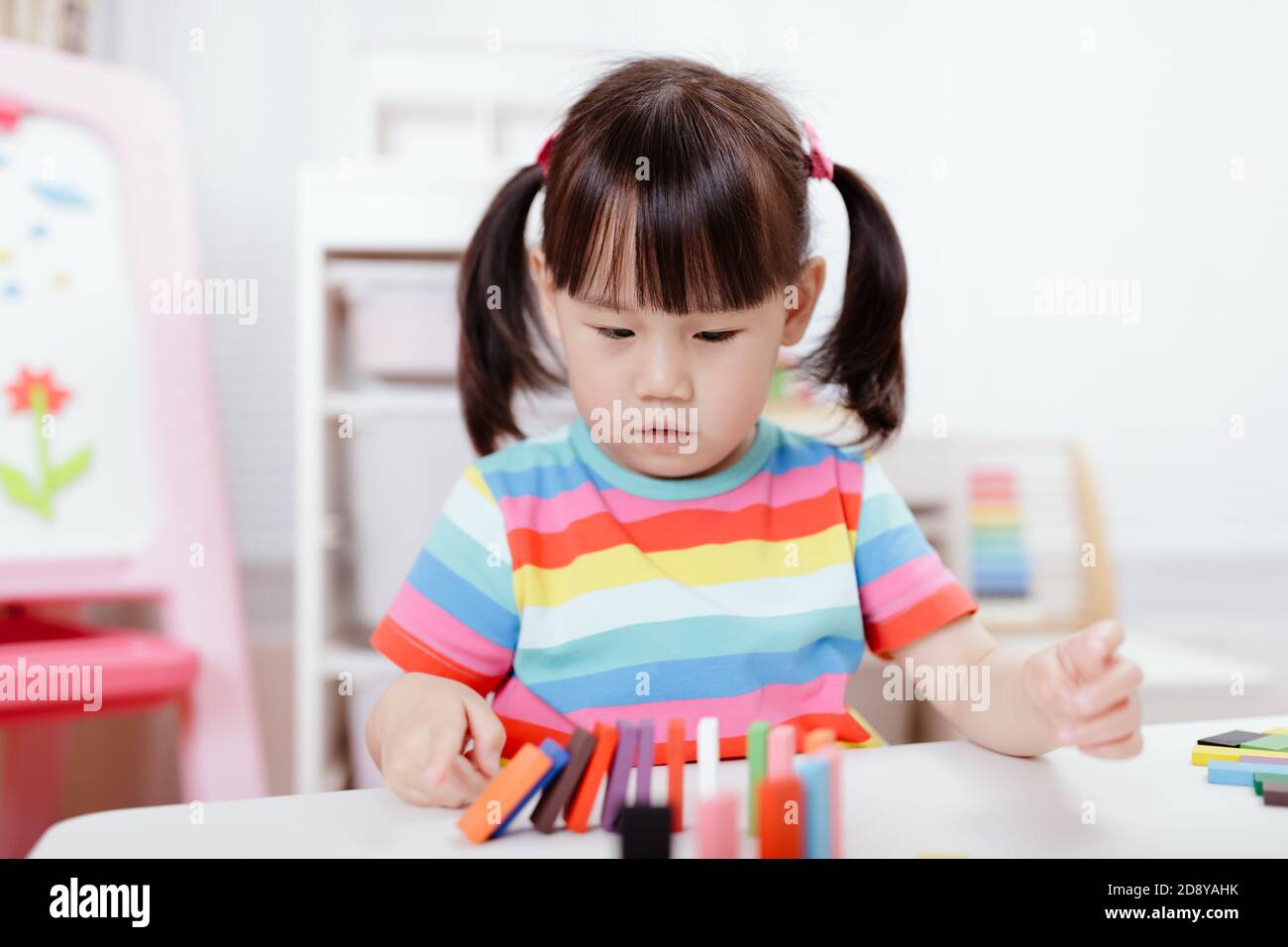 young girl play number sticks fine motor skill game for homeschooling ...