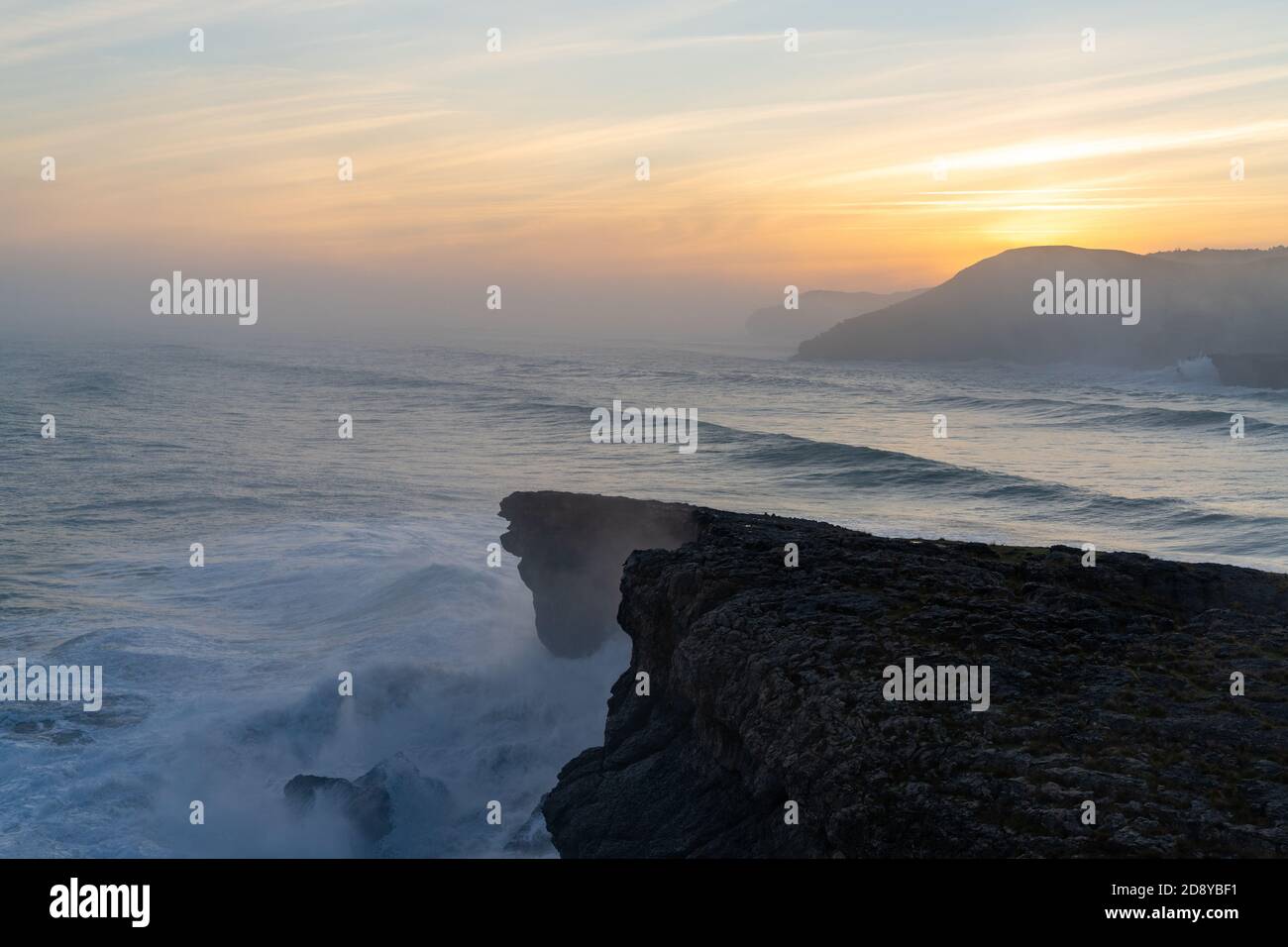 A view of huge storm surge ocean waves crashing onto shore and cliffs ...