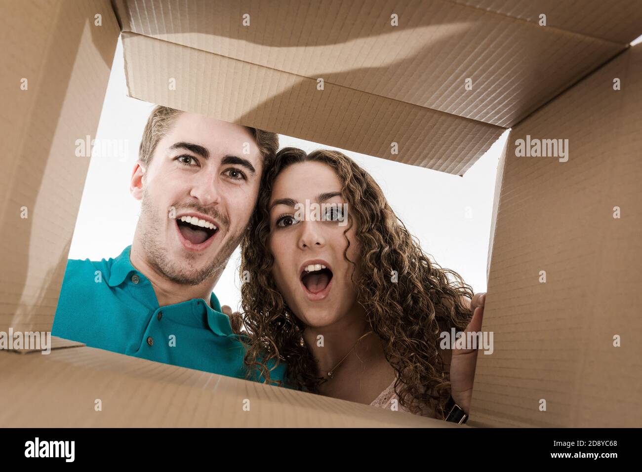 Couple opening cardboard box very happy with what's inside the box ...