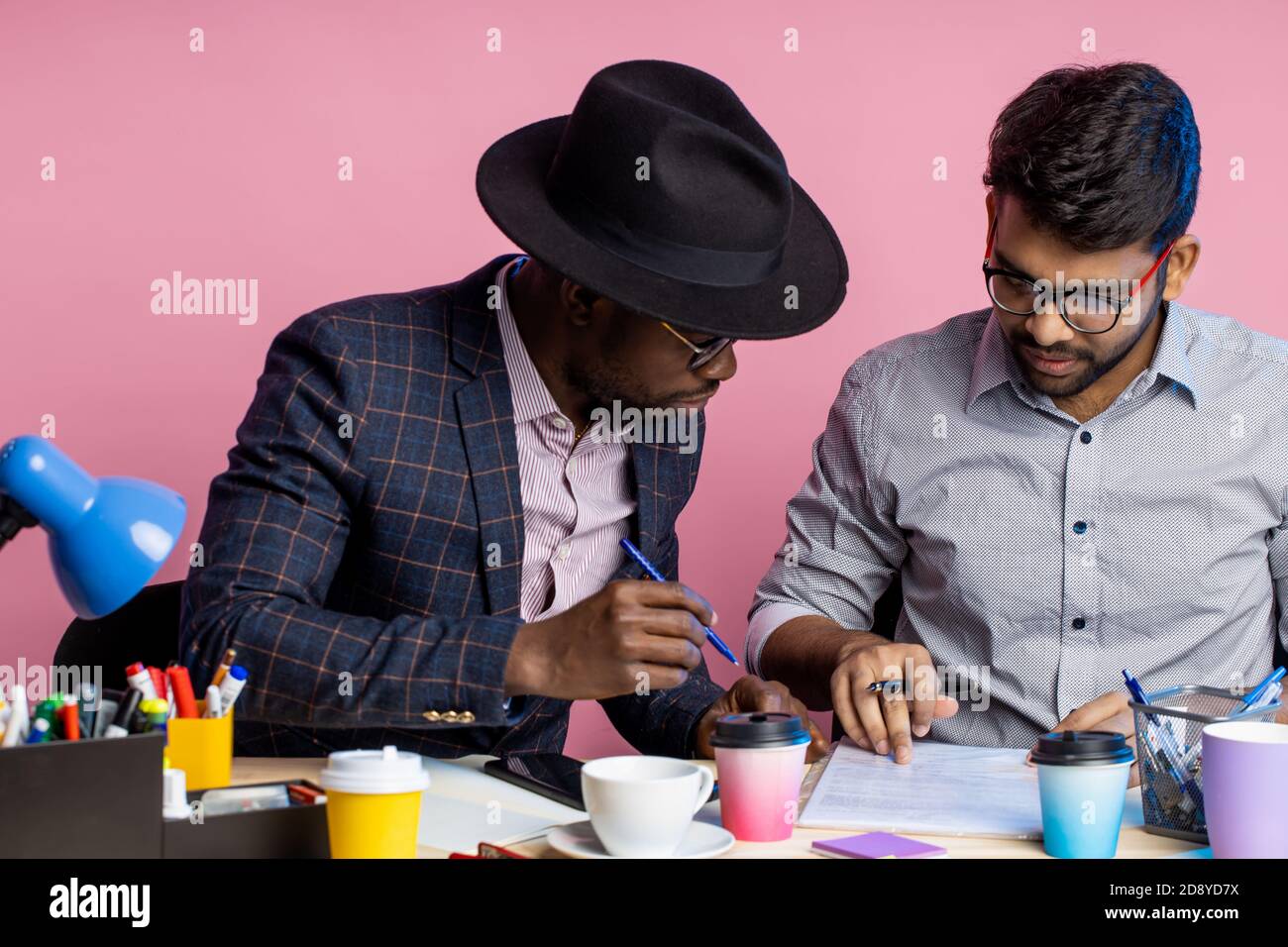african american businessman and indian enterpreneur discussing ...