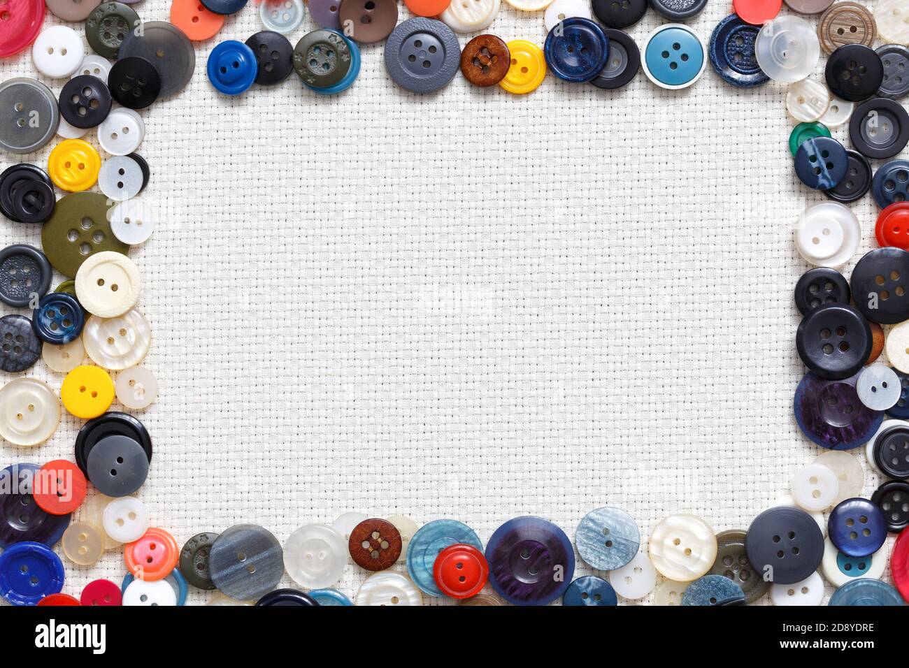 Multi-colored buttons on a white woven background in the form of a ...