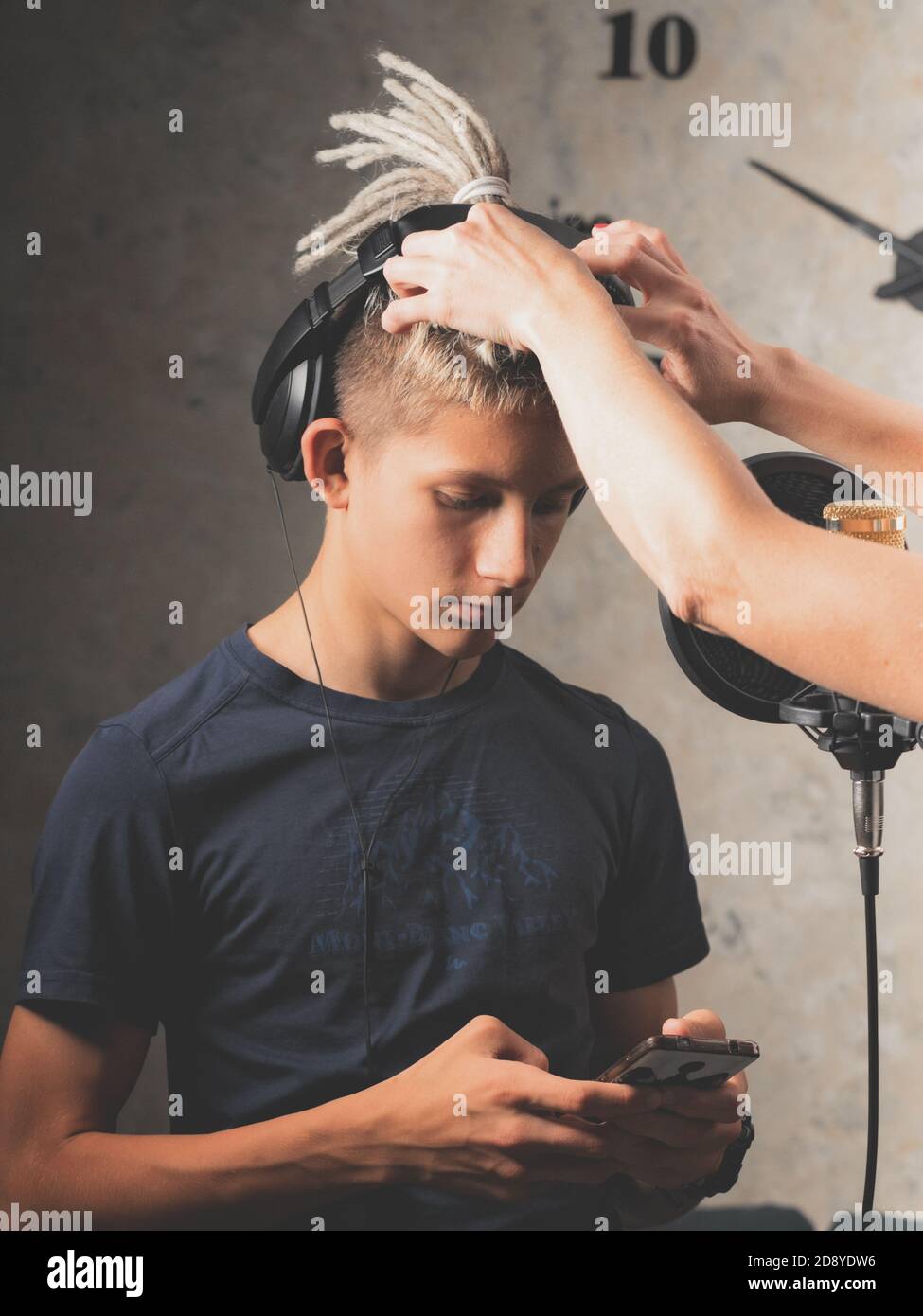 The stylist corrects hairstyle young singer during the recording in the ...
