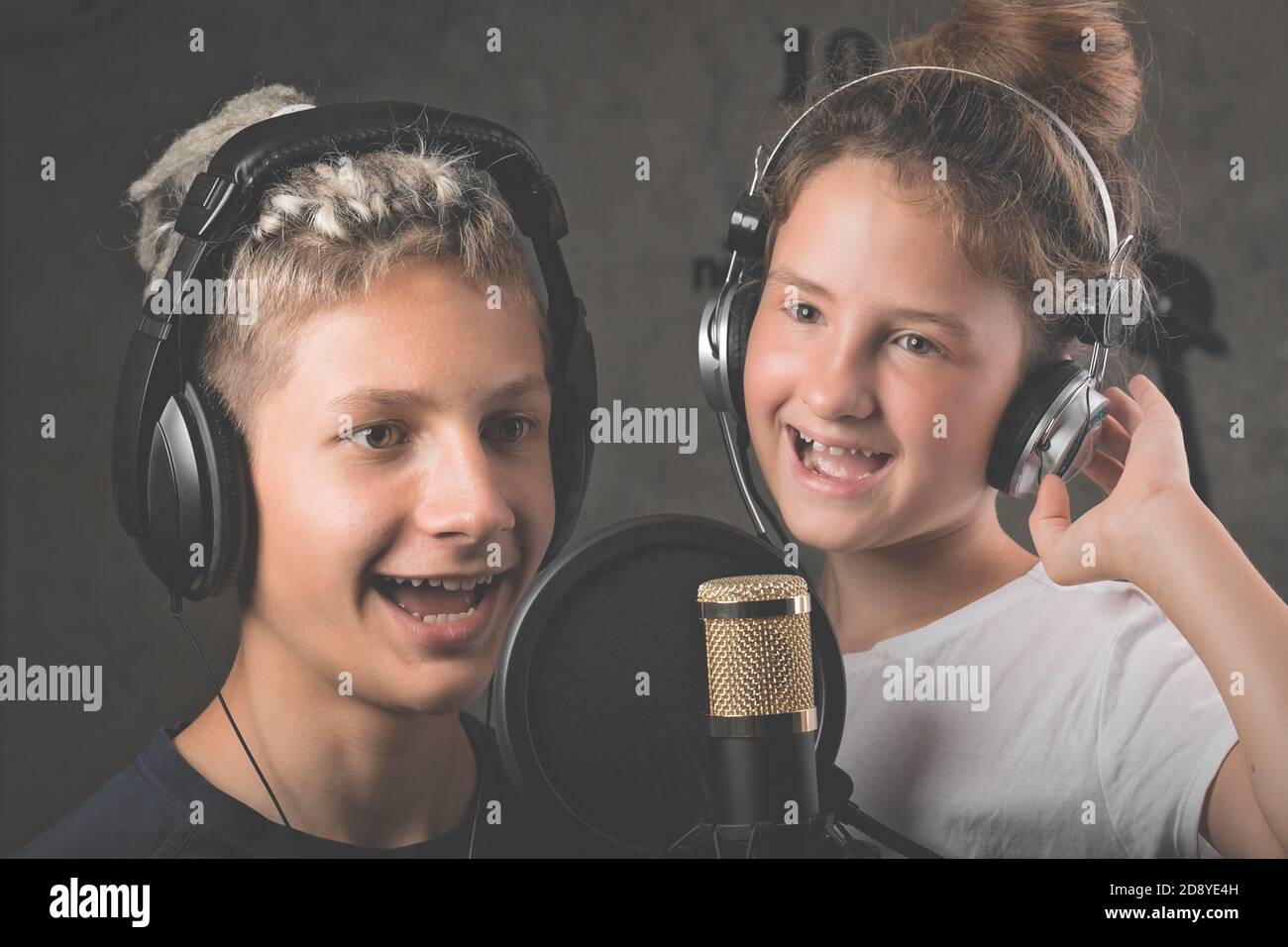 Young singer and a teenage girl are recording a single together in the ...