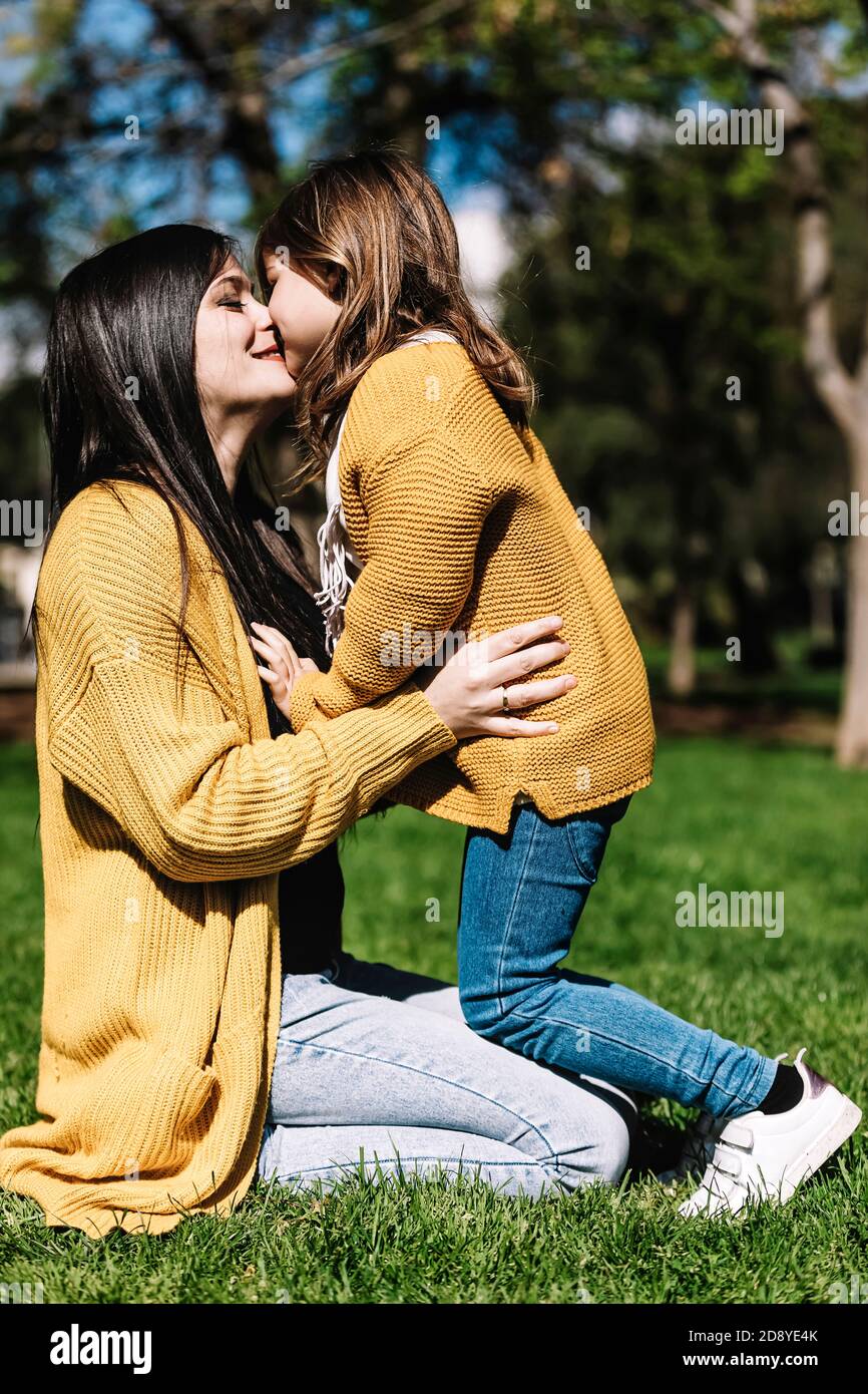 Little cute child baby girl kiss on cheek and hug, embrace with happy ...