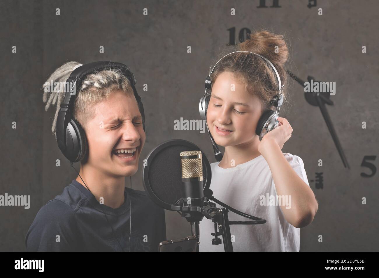 Young singer and a teenage girl are recording a single together in the ...