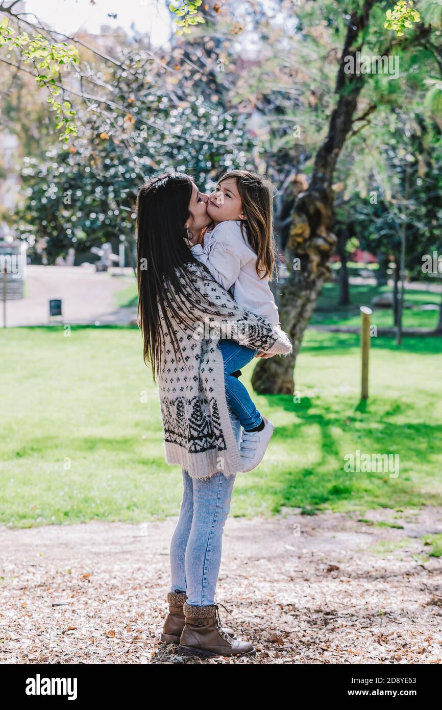Little cute child baby girl kiss on cheek and hug, embrace with happy ...