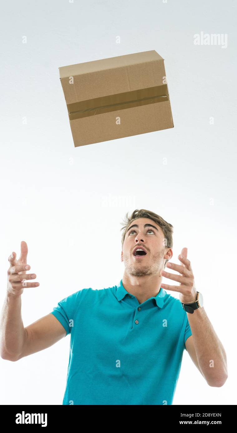 Boy carrying boxes of cardboard with things to send to transport ...