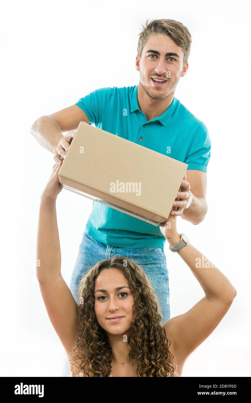Couple throwing cardboard boxes high, happy and surprised by what's ...