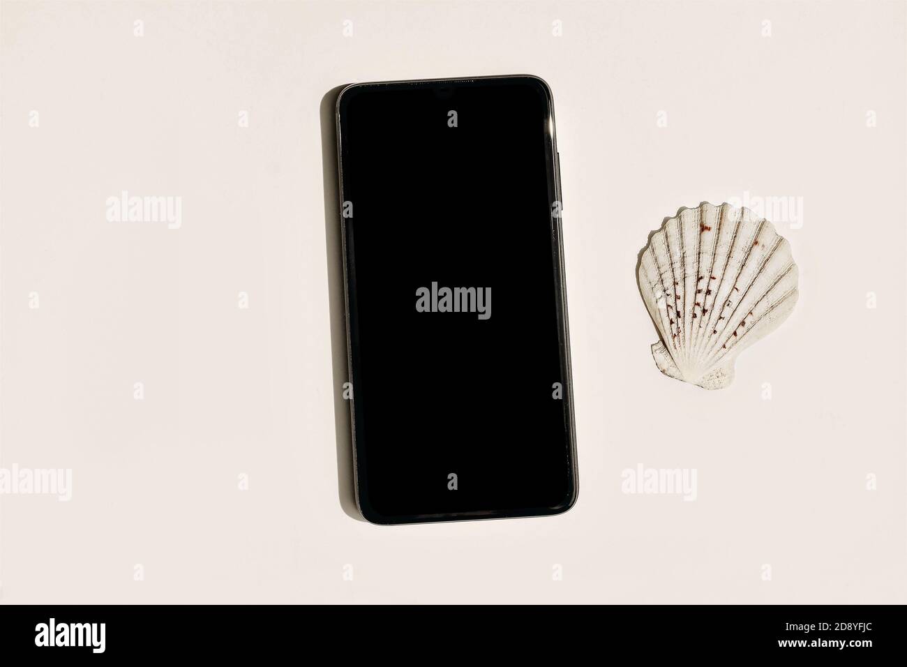 Modern electronic device still life. Black cell phone mock up with sea ...