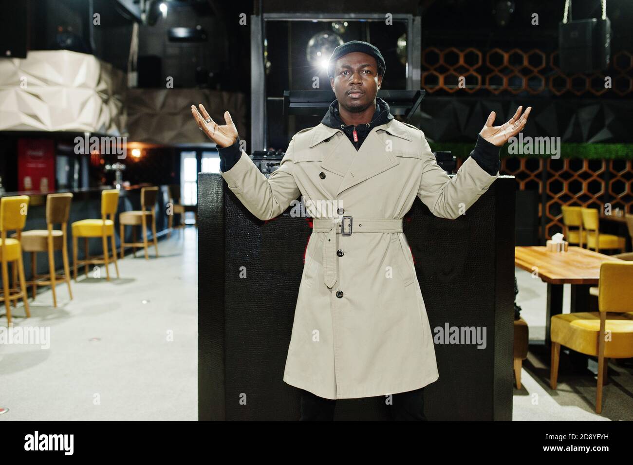 Handsome african american man posing inside night club in black hat and ...
