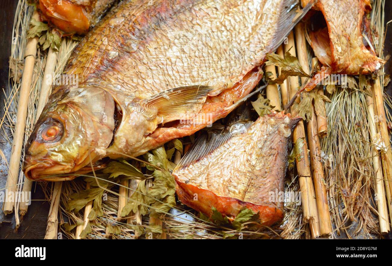 Long-cooked fish. Baked in a Russian oven on straw Stock Photo - Alamy