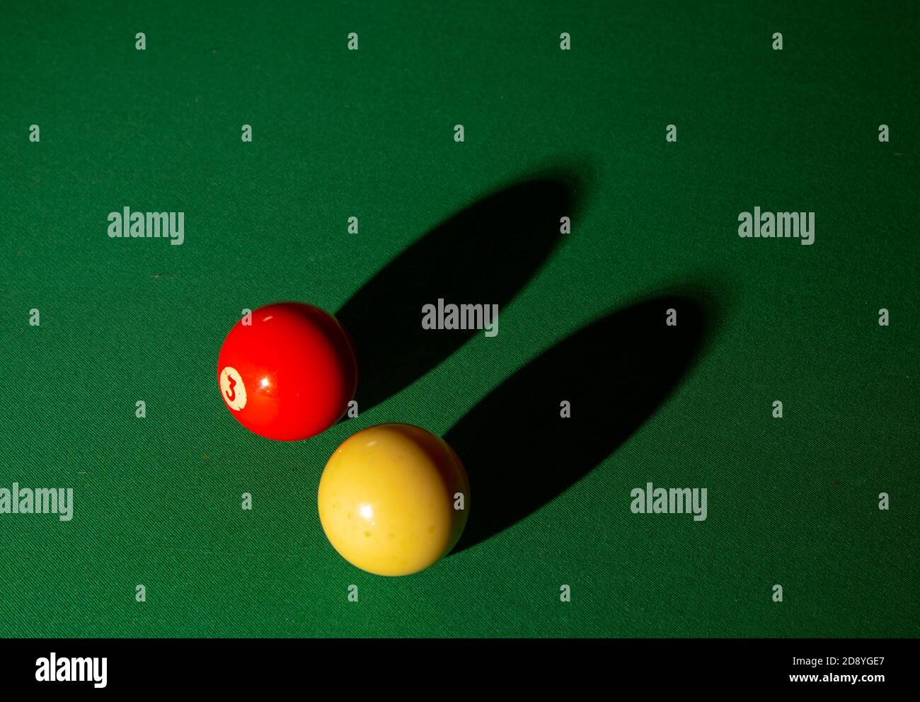 One billiard ball casts a long black shadow on the table surface Stock ...