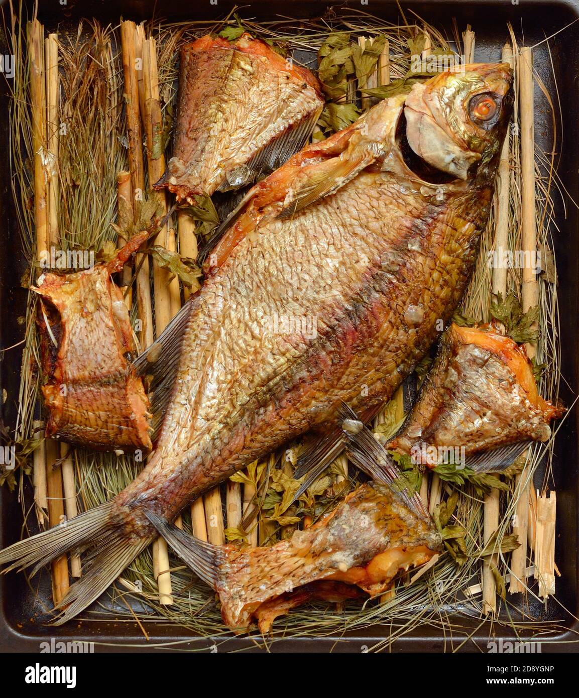 Long-cooked fish. Baked in a Russian oven on straw Stock Photo - Alamy