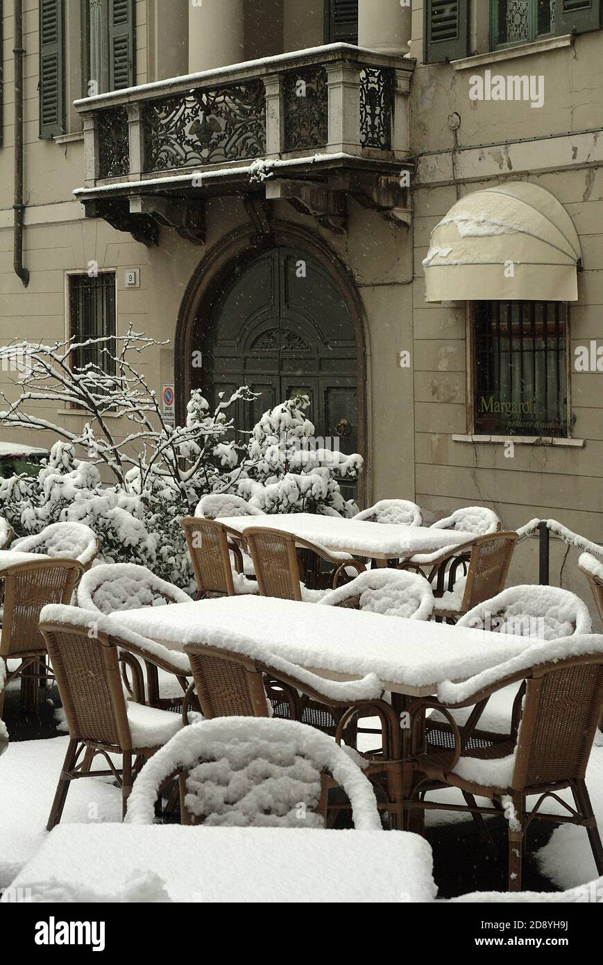 some tables of a bar during a snowfall Stock Photo - Alamy
