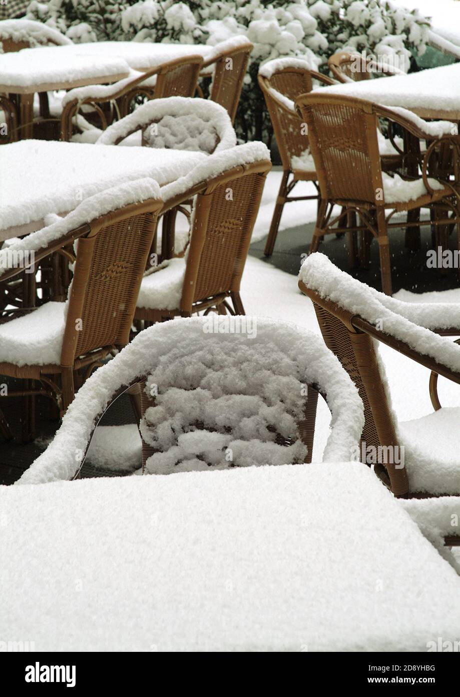 some tables of a bar during a snowfall Stock Photo - Alamy