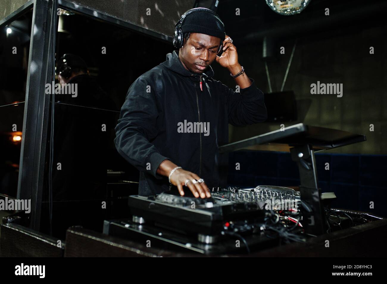 African american dj play music on decks at night club Stock Photo - Alamy
