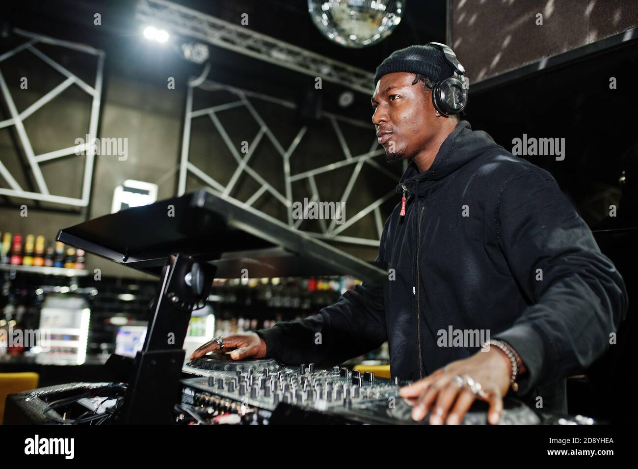 African american dj play music on decks at night club Stock Photo - Alamy