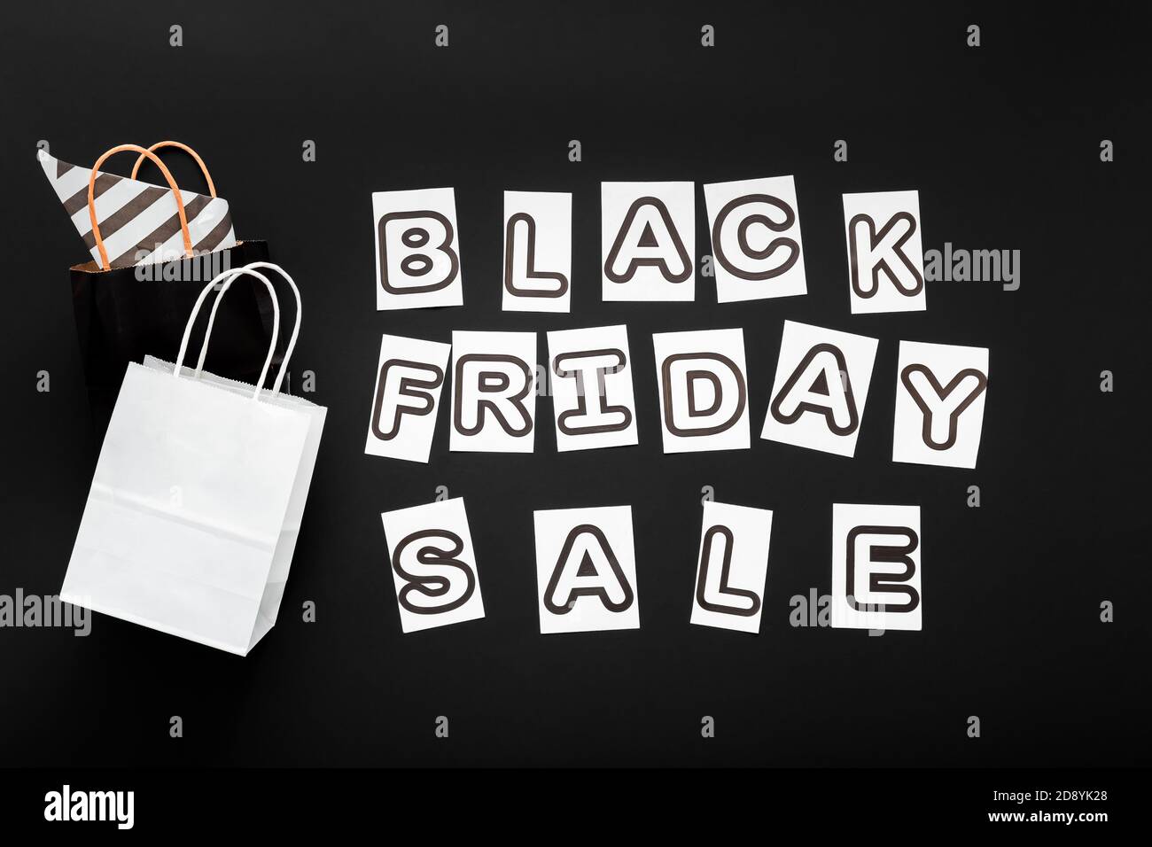Black Friday sale text lettering with shopping paper bags on black ...