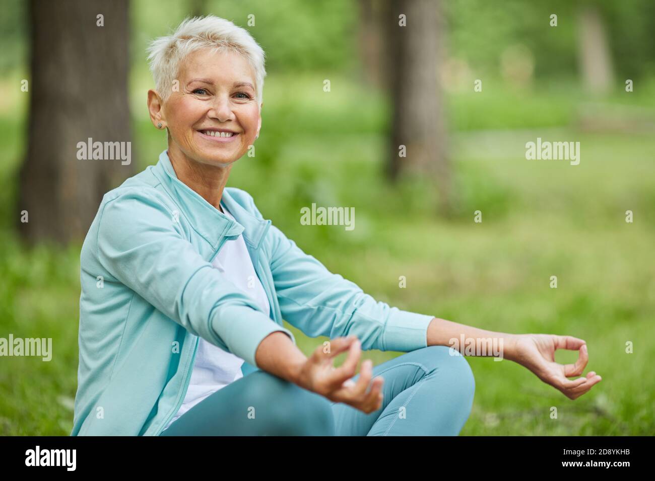 Medium long portrait of senior woman spending morning time sitting on ...