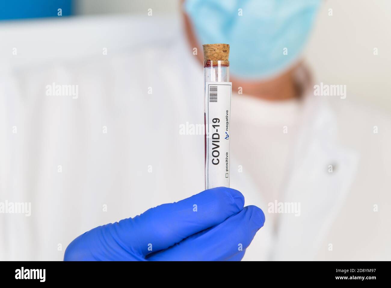 Doctor with positive covid-19 test Stock Photo - Alamy