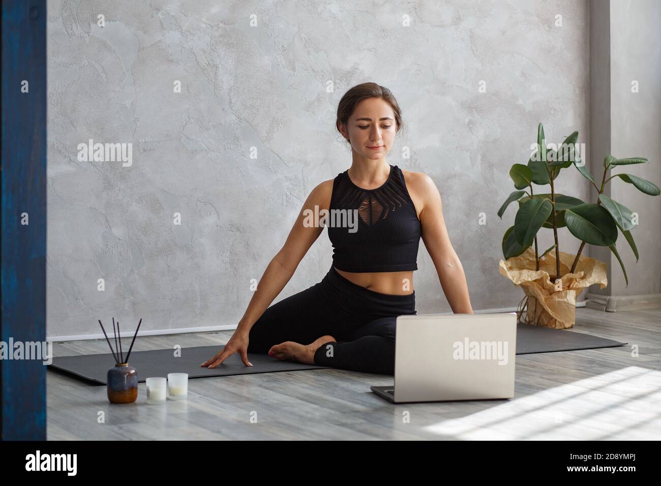 Young sporty female yoga instructor coaching online, making video of ...