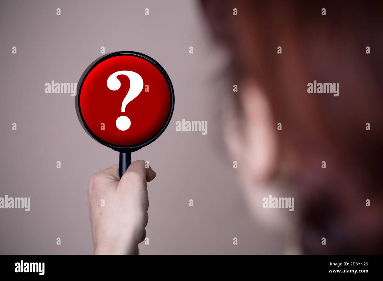 Female person holding a mirror with question mark in it Stock Photo - Alamy