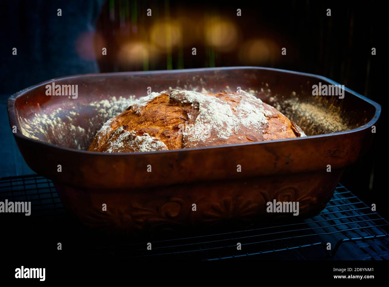 Traditional wheat and rye bread baked at home in a clay pot known as a ...