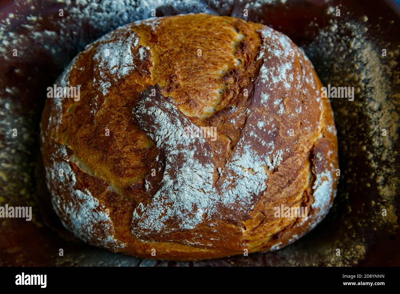 Traditional wheat and rye bread baked at home in a clay pot known as a ...
